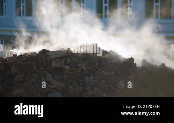 Concept of the breakthrough of underground utilities. steam breaks out ...