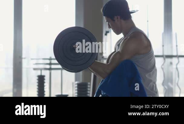 A shirtless guy at the gym, trains his body to stay fit and have ...