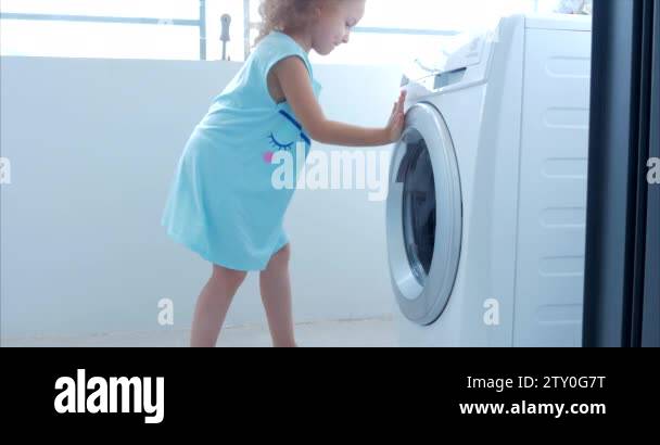 Cute Child Looks Inside the Washing Machine. Cylinder Spinning Machine ...