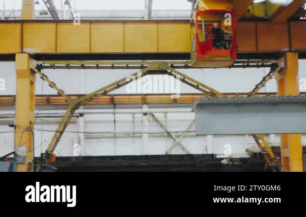 Heavy industry crane moving massive reinforced concrete construction ...
