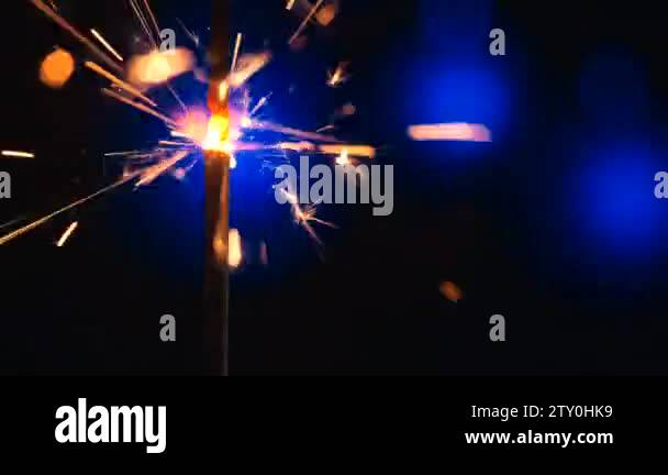 Sparkler Over Blue. Gun powder sparks shot against deep dark background ...