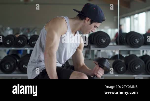 A shirtless guy at the gym, trains his body to stay fit and have ...