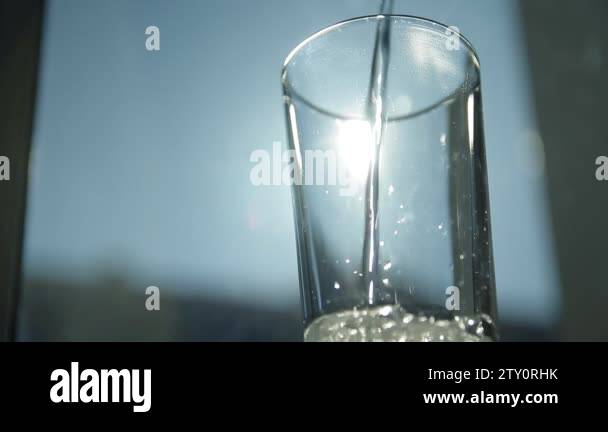 Extreme close-up of mineral sparkling water poured into a glass at dawn Stock Video Footage - Alamy