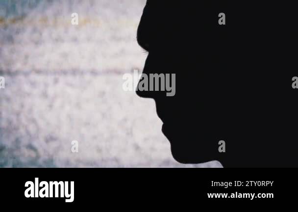 Profile Silhouette of a Male Face on a TV Screen with White Noise and ...