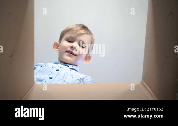 Little boy opens a parcel box of emotions and being surprised Stock ...