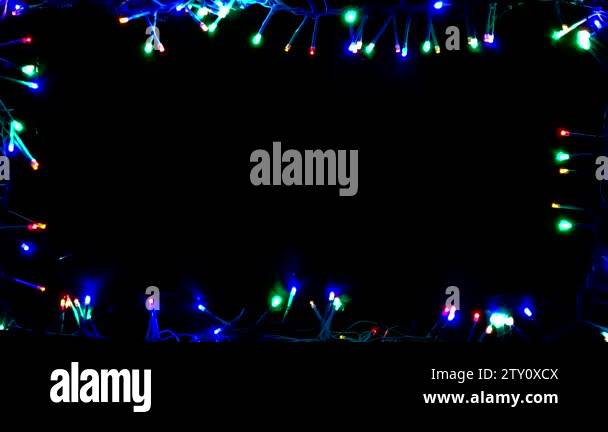 Garland flickering blue, red, green on a black background. A multi ...