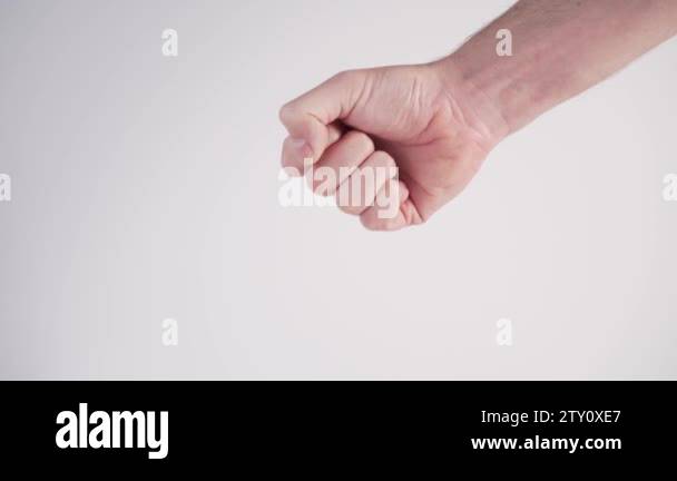 A young man shows numbers from 1 to 5 using his fingers on a white ...