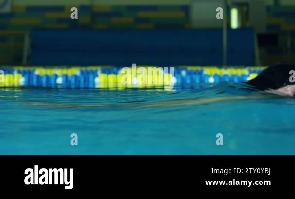 expert swimmer trains at the pool before a race, swimming keeps you fit ...