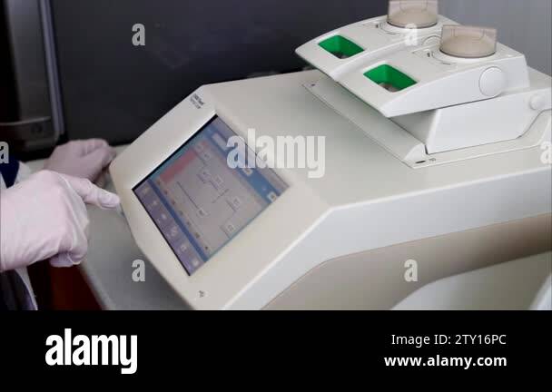 Scientist with gloved hand is programming DNA analysis in real-time PCR ...