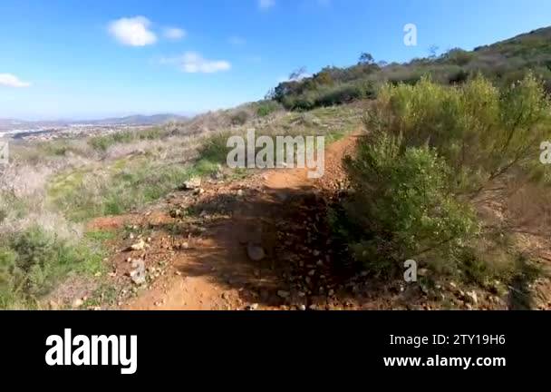 Walking through small trails to the top of the Black Mountain in San ...