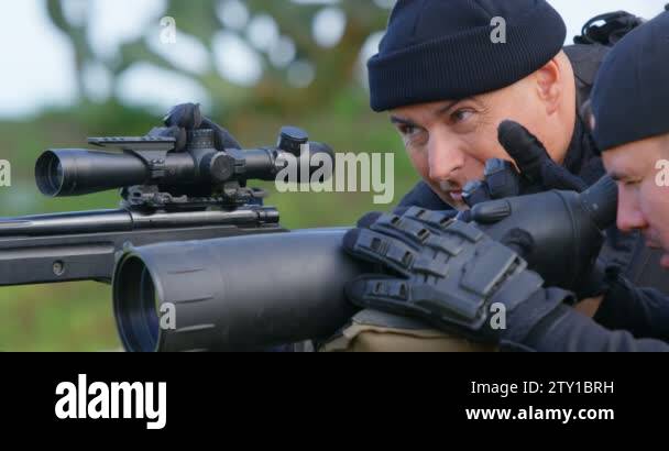 Side view of caucasian military soldiers looking through binoculars and ...