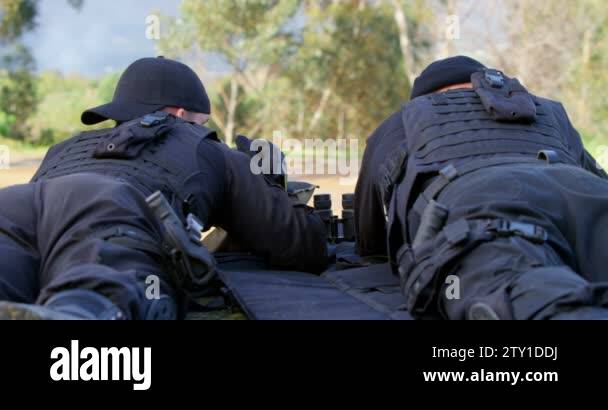 Rear view of caucasian military soldiers looking through binoculars and ...