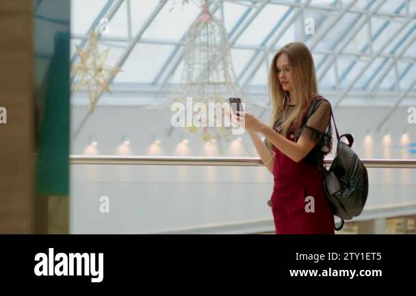 Girl with a backpack talking on video coll through headphones and a ...