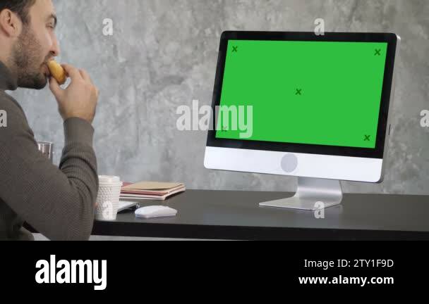 Busy businessman having late lunch eating sandwich in office working ...