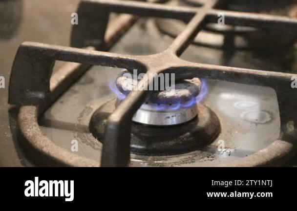 Increasing of flame on the kitchen cooktop gas cooker close up on the ...