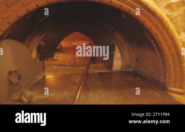 Brick oven with burning firewood, pizza and long peel. Italian fire ...