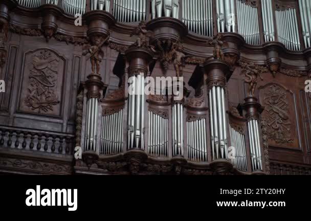 Antique carved wood organ in a catholic temple. Beautiful wood carving ...