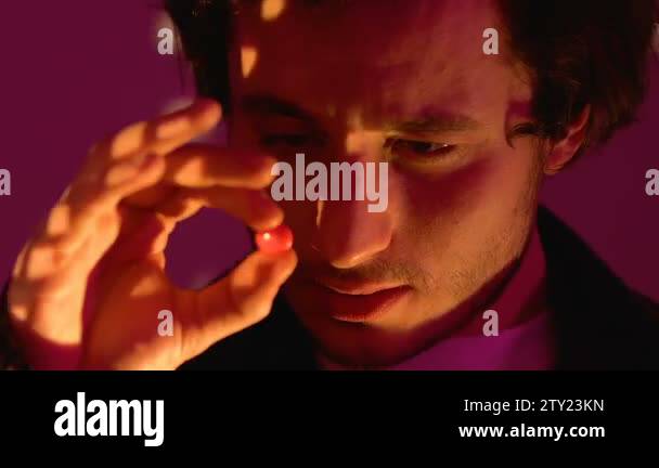 Relaxed man dancing at night club party, taking ecstasy pill, drug ...