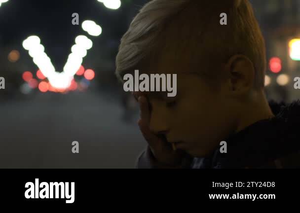 Upset lonely boy crying, standing alone in big city, depression and ...