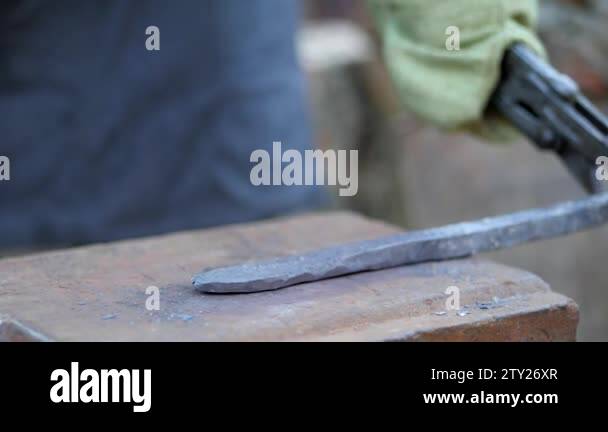 blacksmith works metal. Craftsman, the Highlander on private smithy in ...