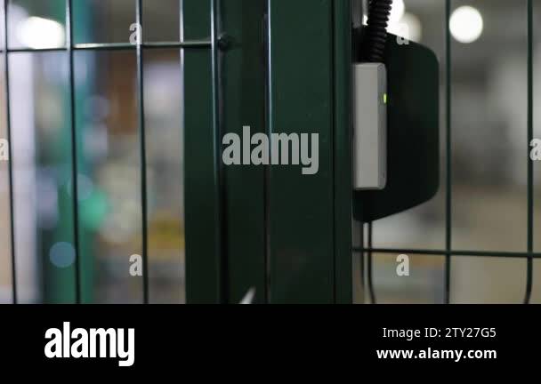 manufacturing engineer is opening electromagnetic lock of door in a ...