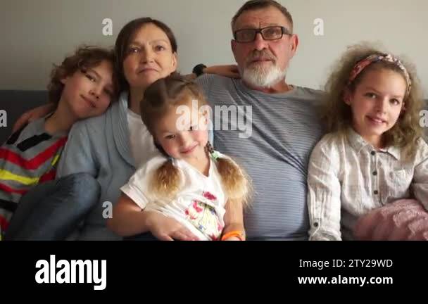Close portrait of a big happy family. Grandparents are sitting on the ...