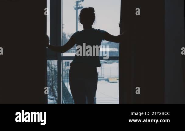 Young models in a modern high-rise house with full length windows ...