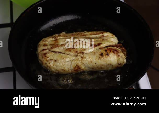 In a heated frying pan in butter, the chicken fillet roll is fried. A ...