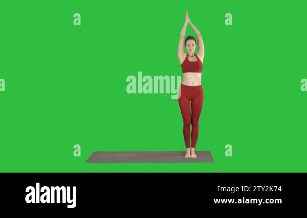 Woman practicing yoga, standing in Extended Side Angle exercise ...