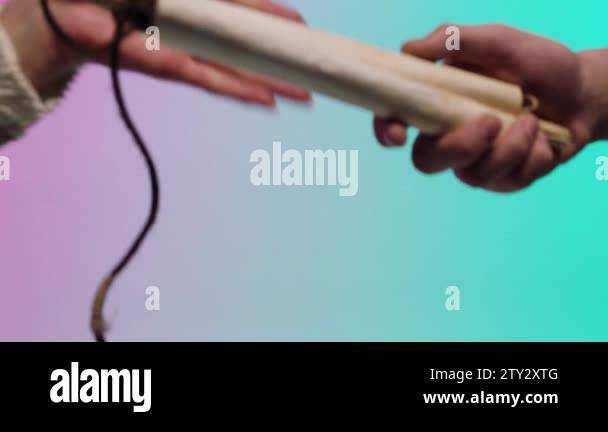 Male hand giving an ancient, rolled manuscript to a woman hand ...