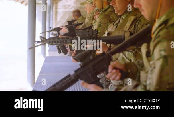 Side view of mixed-race military soldiers loading weapon during ...
