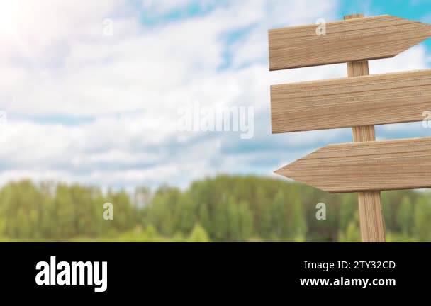 wooden sign pointer on animated background of sky, clouds and sun glare ...