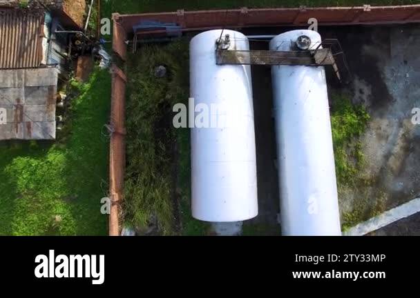 Top view of big silver cisterns, petroleum reservoir at oil storage ...