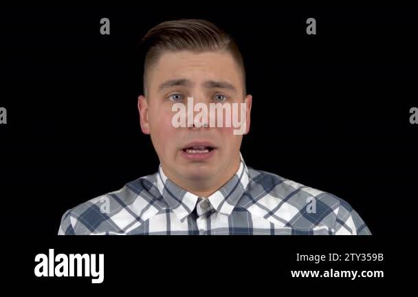 A young man takes off his mask and shows an emotion of fear on his face ...
