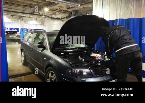 Self service car wash. Man washing his car at automobile washing ...