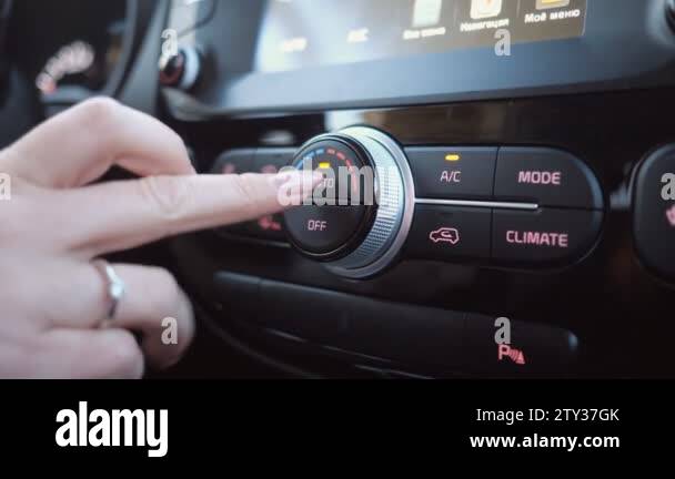 Woman Driving car and pushing buttons on radio, dashboard and wheel ...