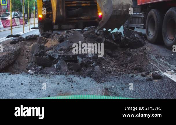Wheel Excavator Digging a Hole. Repair work on the motorway. Excavator ...