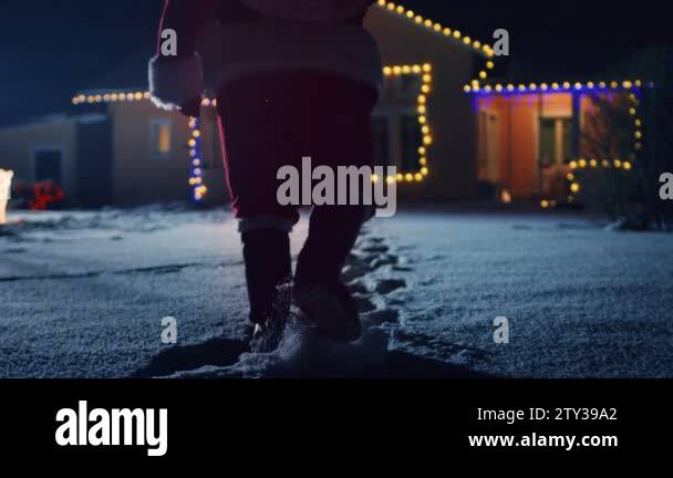 Low Angle Footage of Santa Claus with Red Bag, Walks into Front Yard of ...