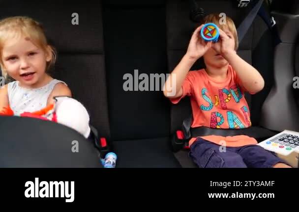 Brother and sister ride in the back seat of the car without car seats ...