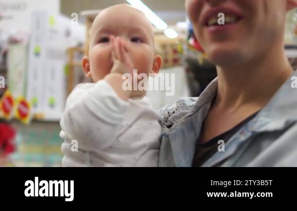 Father and his little son are choosing a toy. The kid rejoices at the ...
