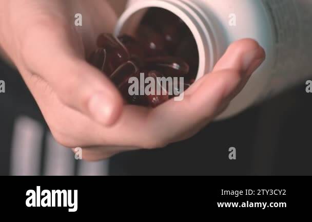 Boy spill back in bottle nutritional supplement capsules Stock Video ...