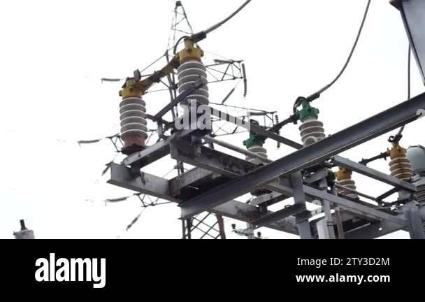 Earthing switch and electricity transmission line on a birch and bright ...