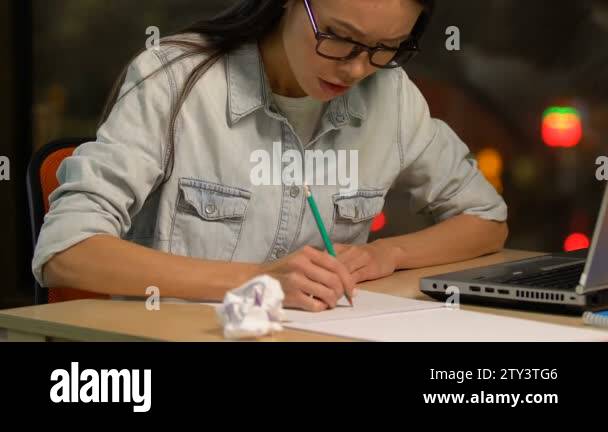 Upset self-employed lady having no ideas, crumpling and throwing out ...