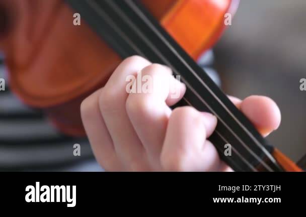 Violin in boys hands. Boy is learning to play violin. Correct setting ...
