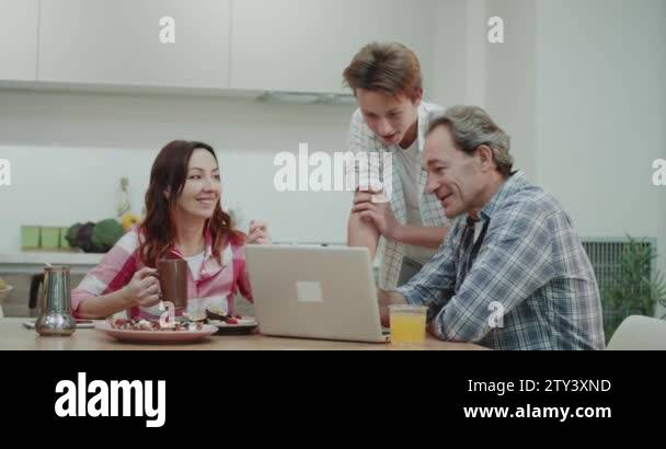 Charismatic young boy explain to his mature parents something how to ...