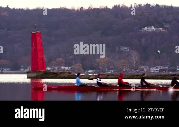 Two teams of rowers row across lake while captain yells words of ...