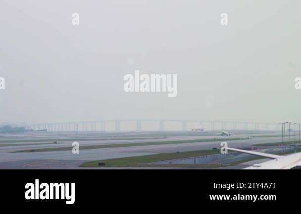 Passenger airplane driving on runway for taking off in airport terminal ...