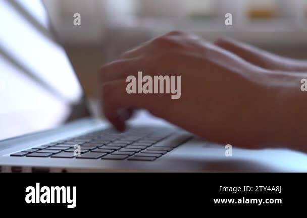 Closeup of hands working and typing on a laptop keyboard with black ...