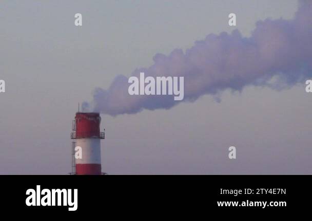 Thick smoke coming from the factory chimneys. Large pipe boiler. There ...