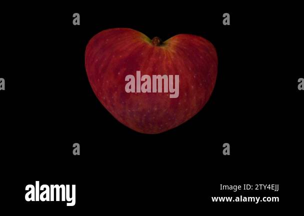 Realistic render of a rotating half Red Delicious apple on black ...